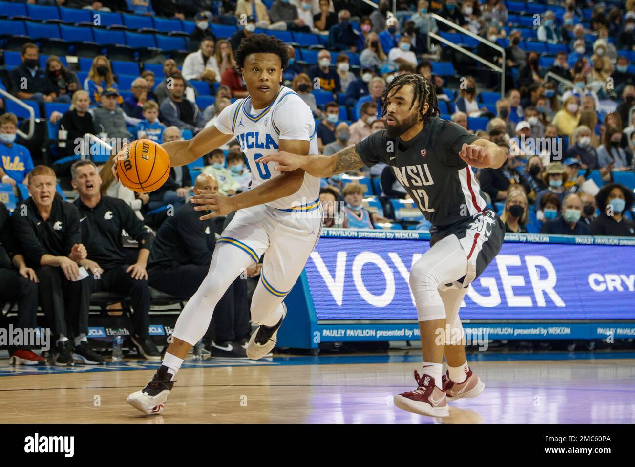 UCLA guard Jaylen Clark (0) drives past Washington State guard Michael ...