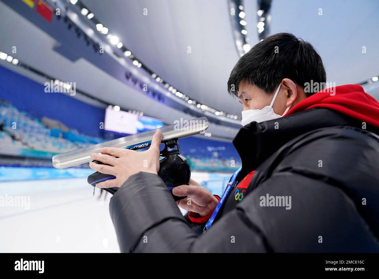 Zhanyu Yang, a speedskating coach for Team China, check the alignment ...