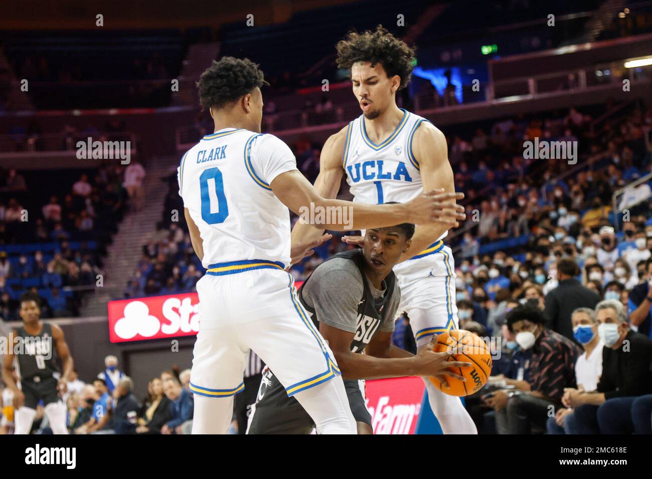Washington State guard Noah Williams (24) struggles with the ball ...
