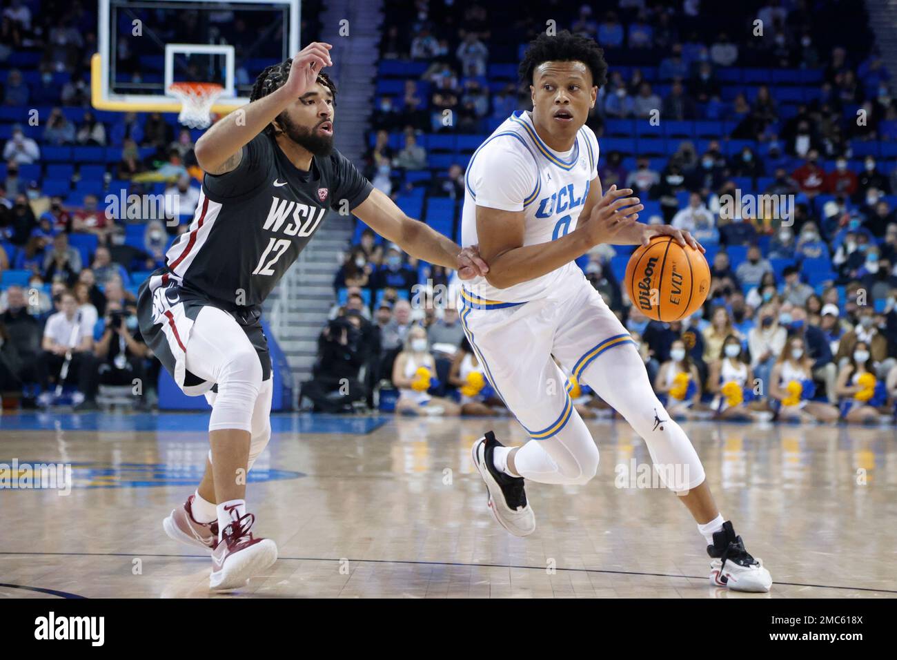 UCLA guard Jaylen Clark (0) drives past Washington State guard Michael ...