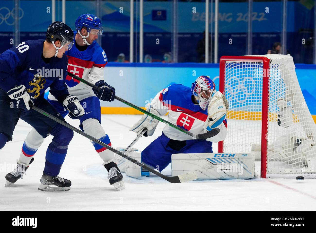 Finland's Saku Maenalanen (80) and Slovakia goalkeeper Patrik Rybar ...