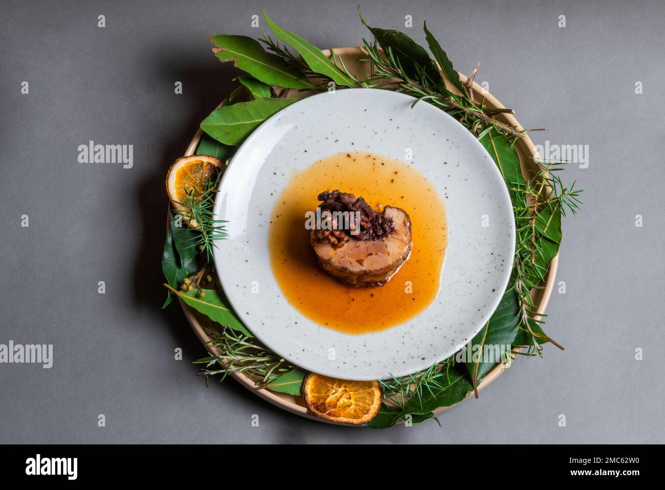 A Birdseye view of a modern plated meal, shot against a plain grey ...