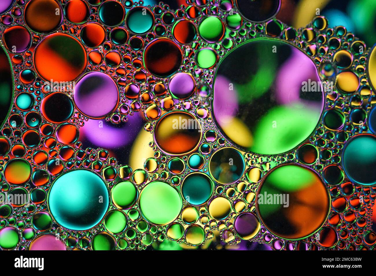 multi colored oil circles on the water, colorful background Stock Photo ...