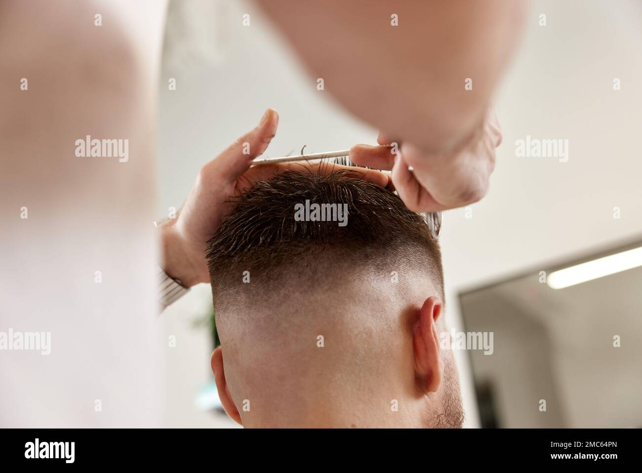 hairdresser does haircut for man using comb and grooming scissors Stock ...