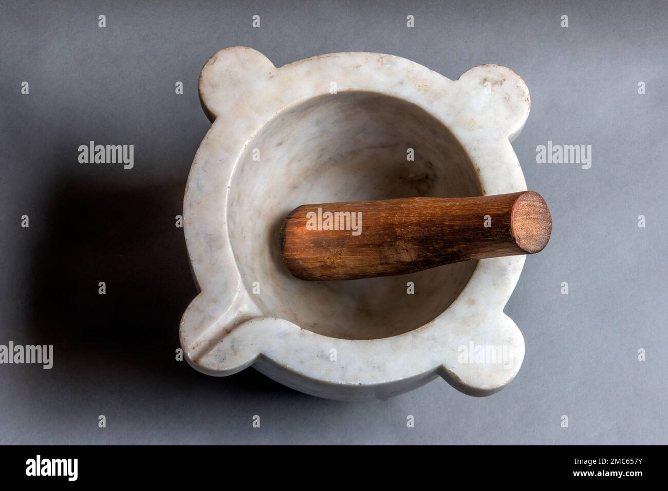 A birdseye studio view of a Marble mortar and wooden pestle Stock Photo ...