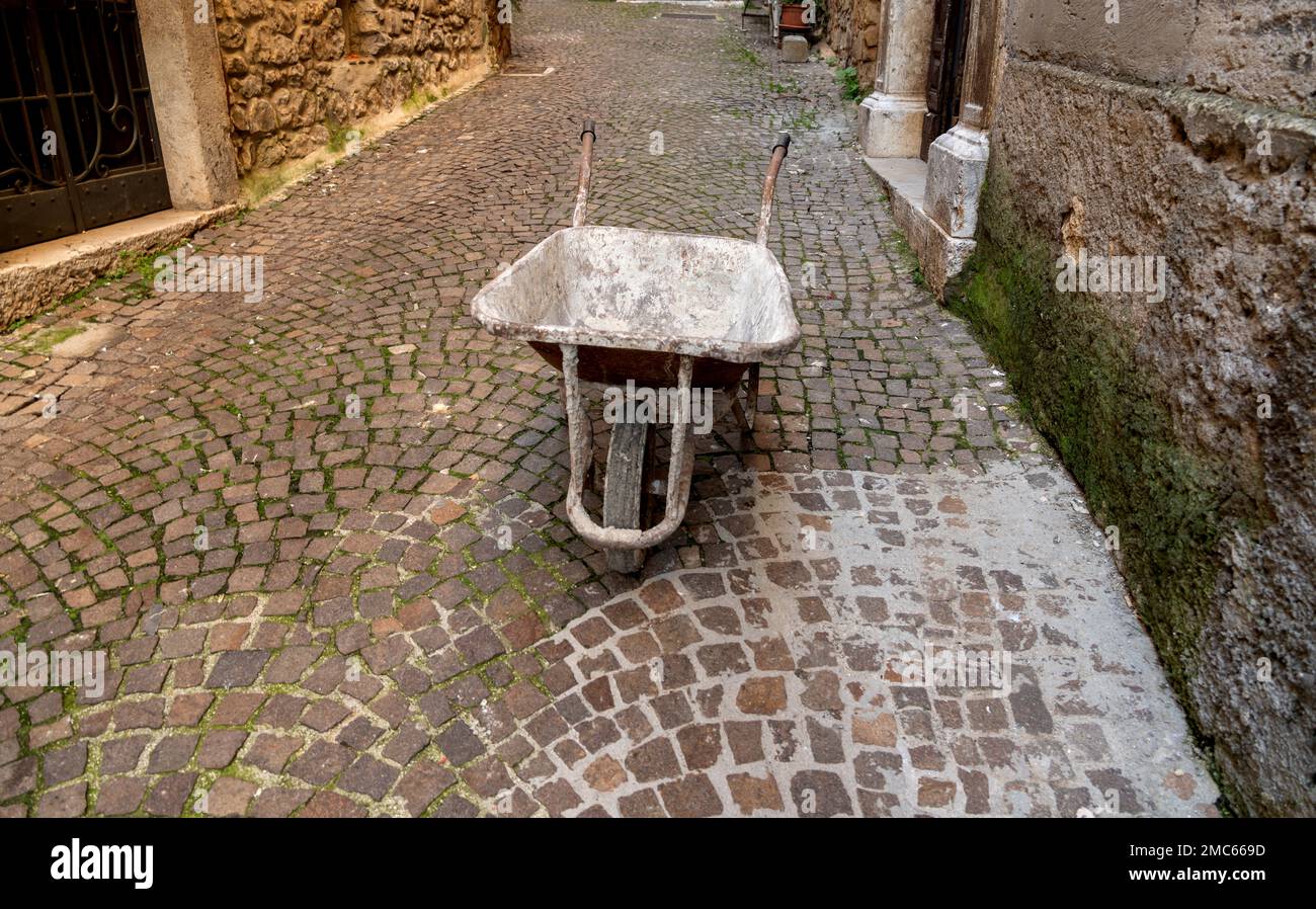 old empty mason's wheelbarrow in a narrow cobbled street Stock Photo ...