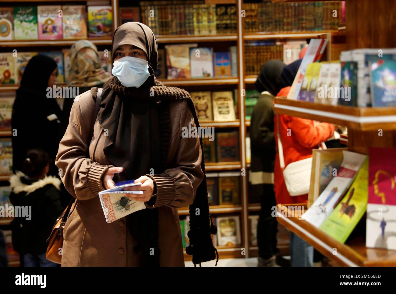 A woman browses book while standing between bookshelves at the Samir ...
