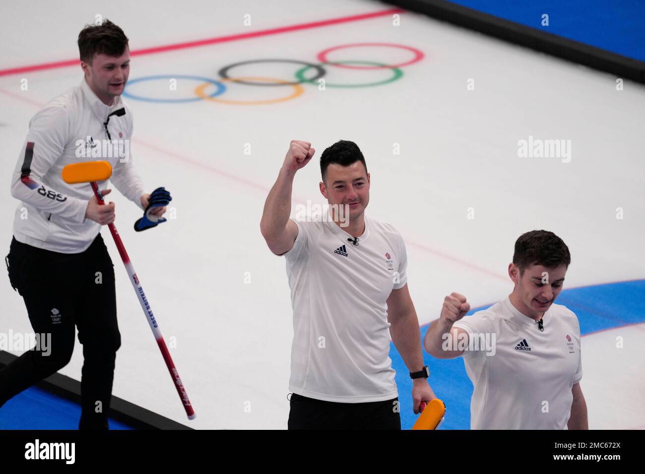 Britain's athletes celebrate after winning the men's curling semifinal ...