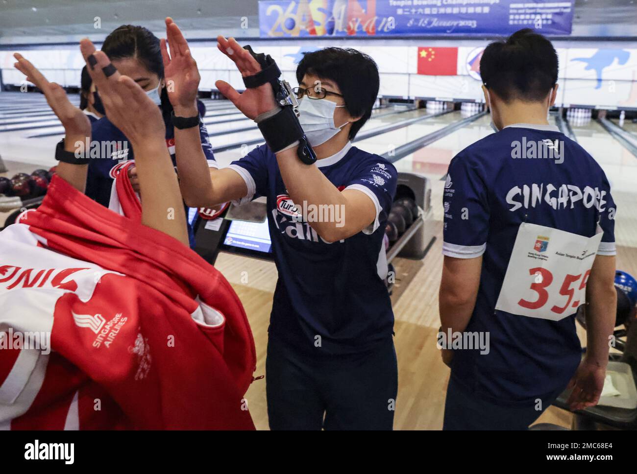 Cherie Tan of Singapore cheers with teammates during the Asian Tenpin ...