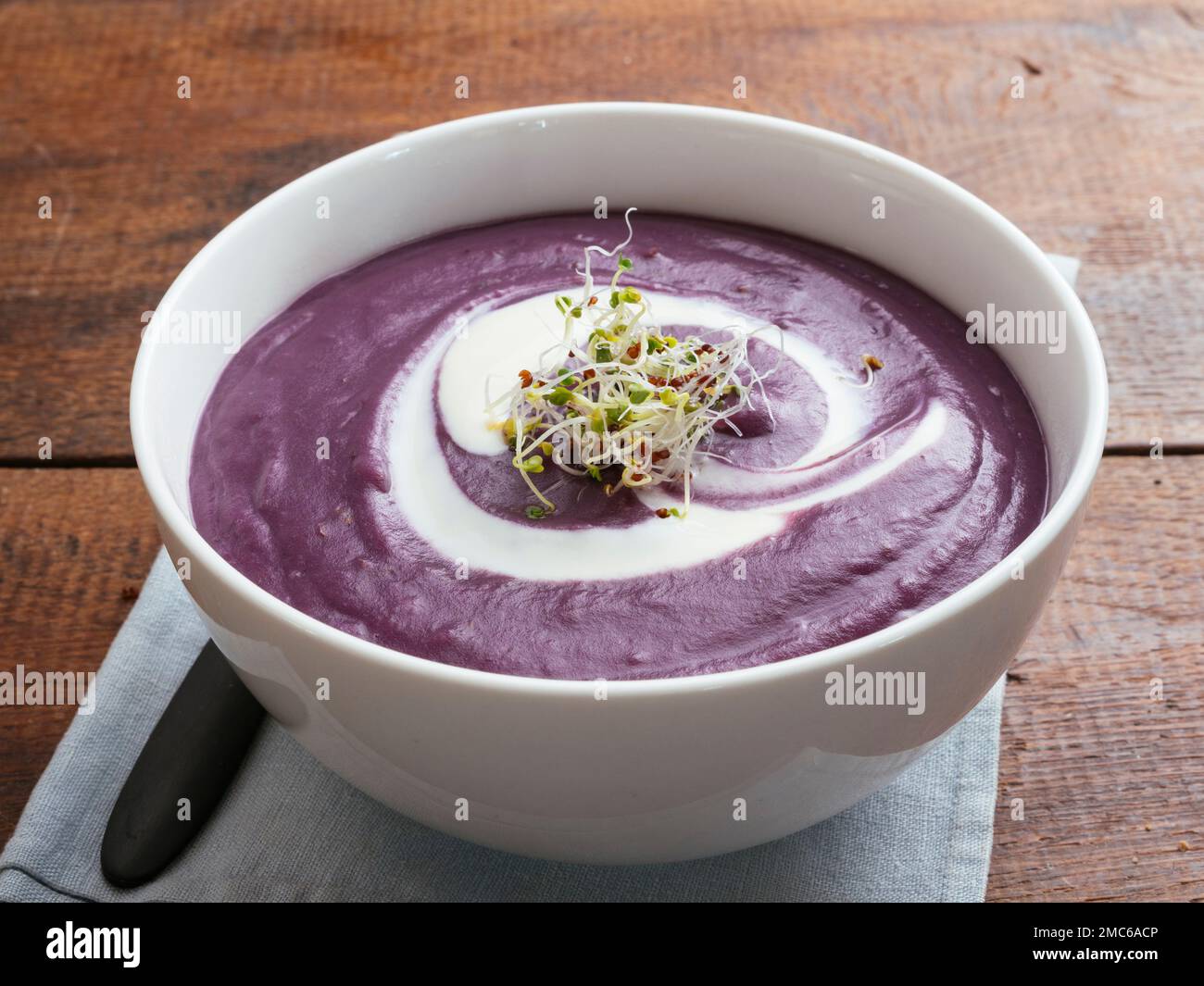 Purple potato soup with soy yogurt and sprouts Stock Photo - Alamy