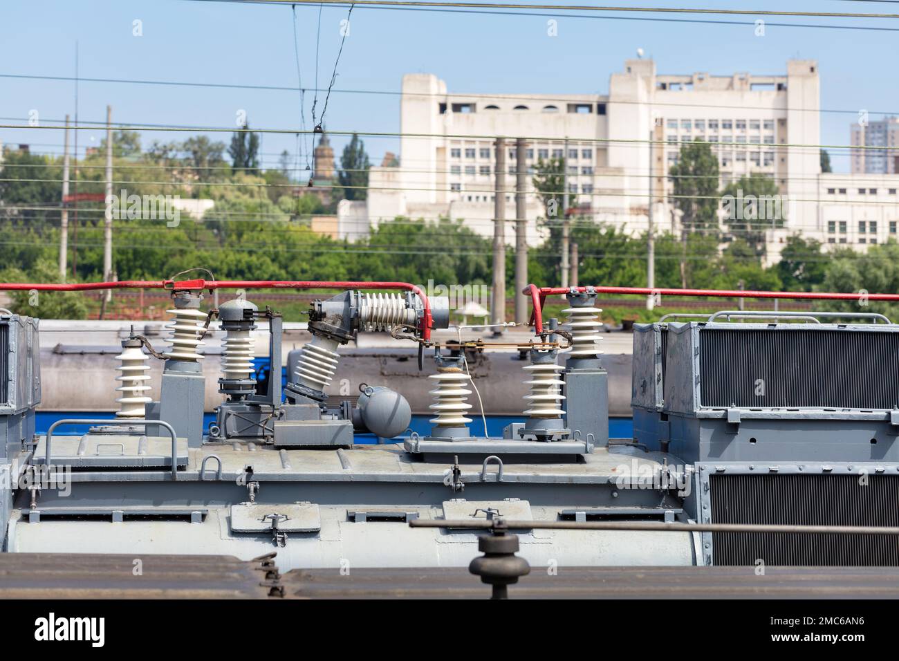 High-voltage pantograph insulators on the roof of a train locomotive ...