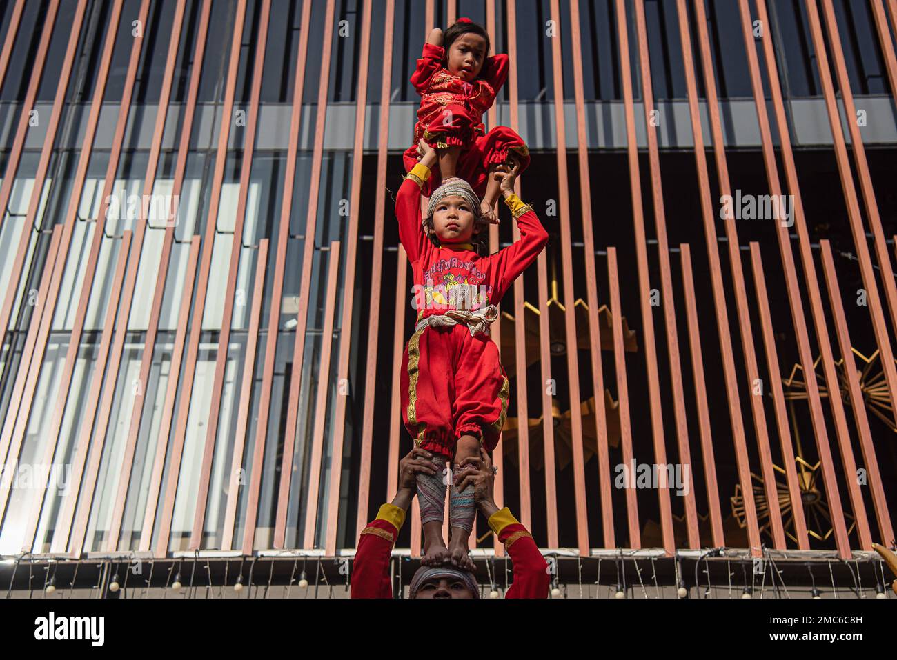 Bangkok, Thailand. 21st Jan, 2023. Young acrobat performs a human tower ...