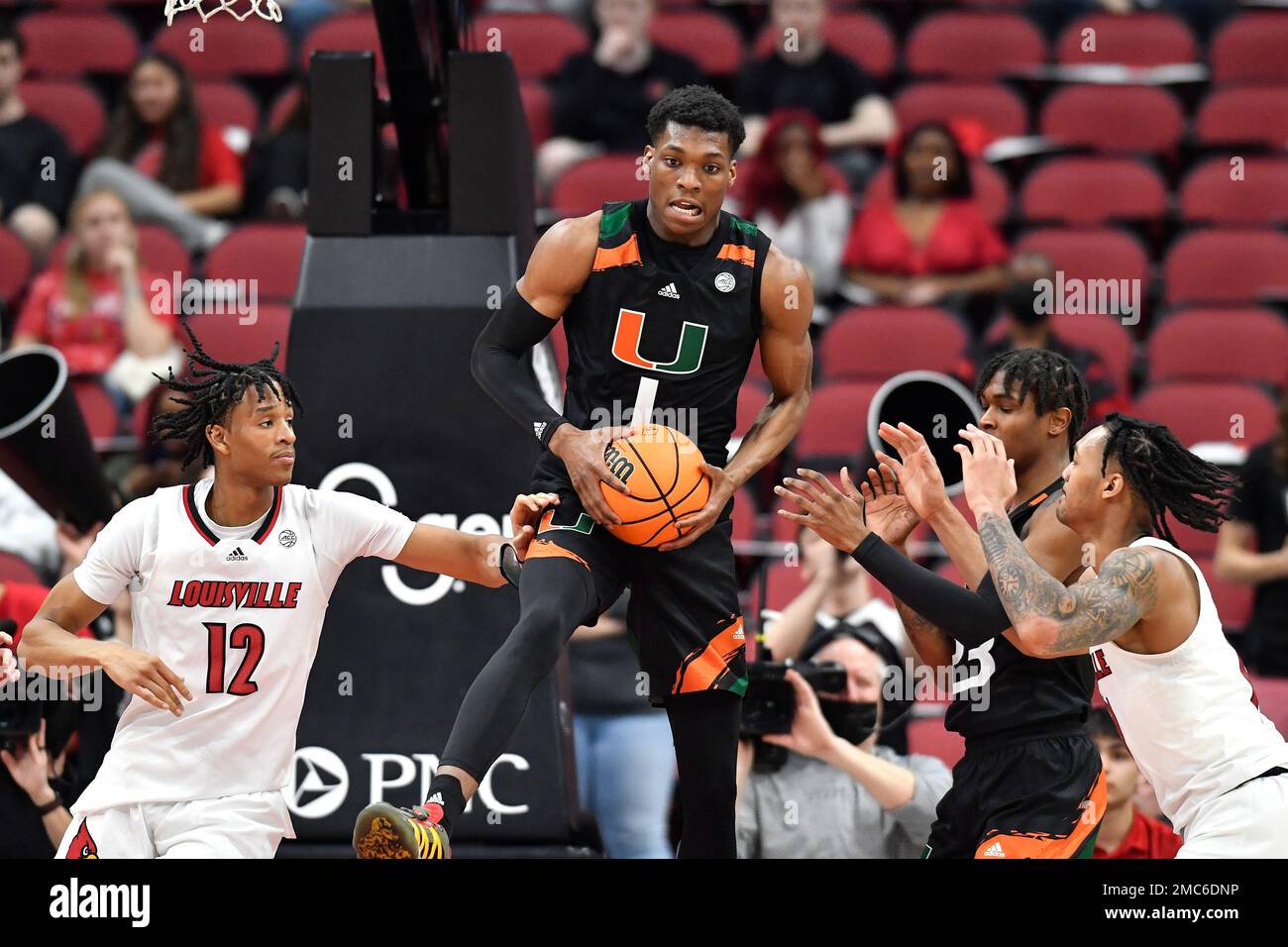 Miami forward Anthony Walker (1) grabs a rebound away from Louisville ...