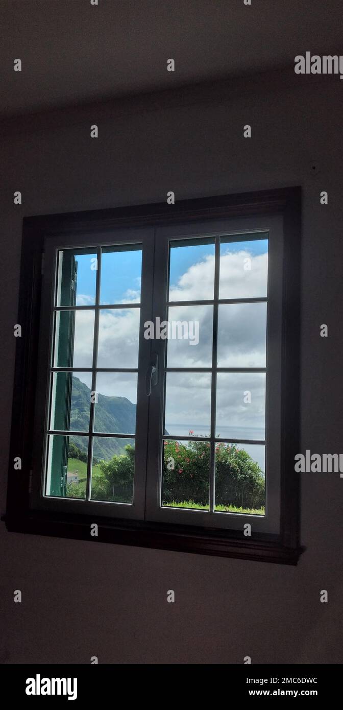 A vertical shot of a multi panel glazed window with a beautiful view ...