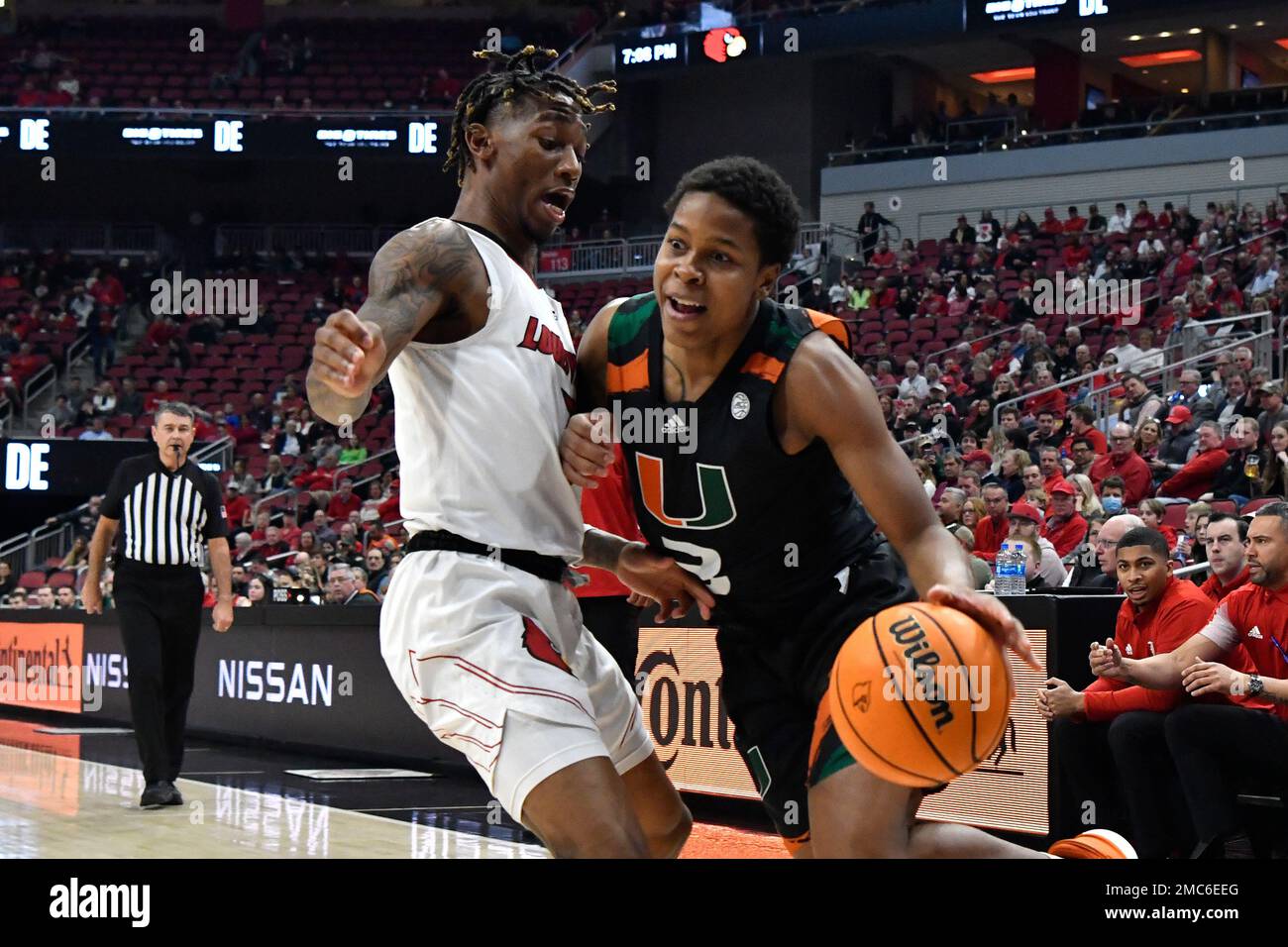 Miami guard Charlie Moore (3) tries to get past Louisville guard El ...