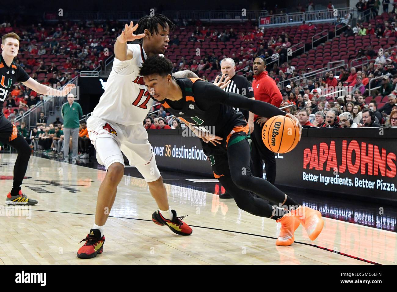 Miami guard Jordan Miller (11) attempts to drive past Louisville ...