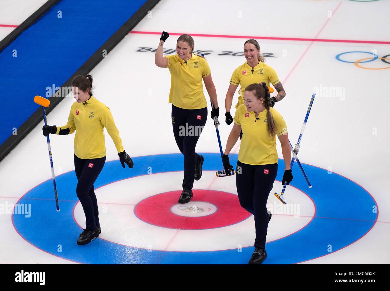 Sweden's team, celebrate after winning the women's curling match ...