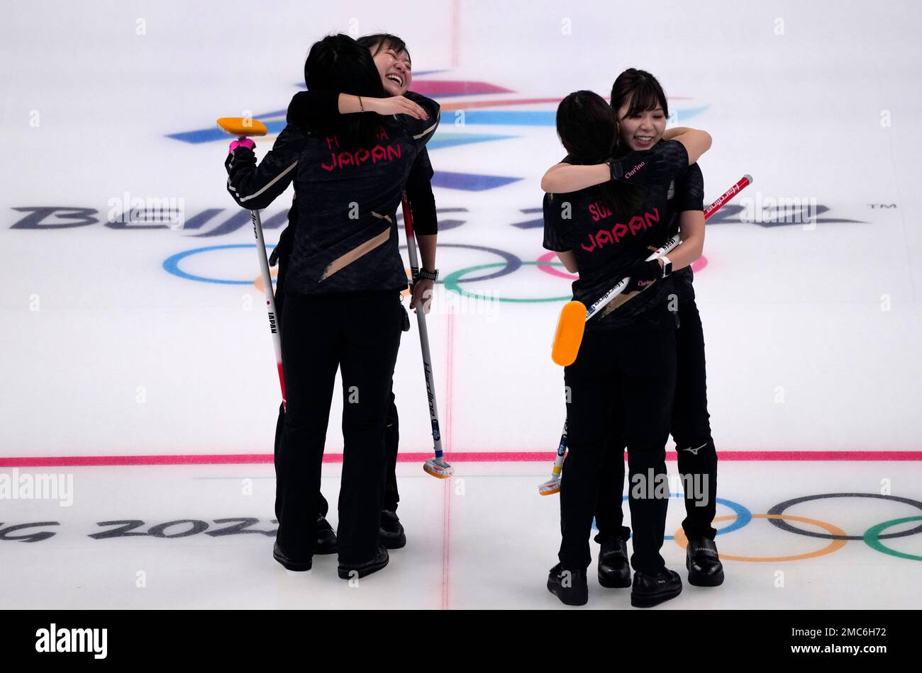 Japan's team, celebrate after winning the women's curling match against ...