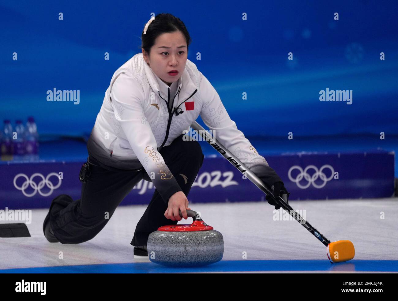 China's Wang Rui, throws a rock, during the women's curling match ...