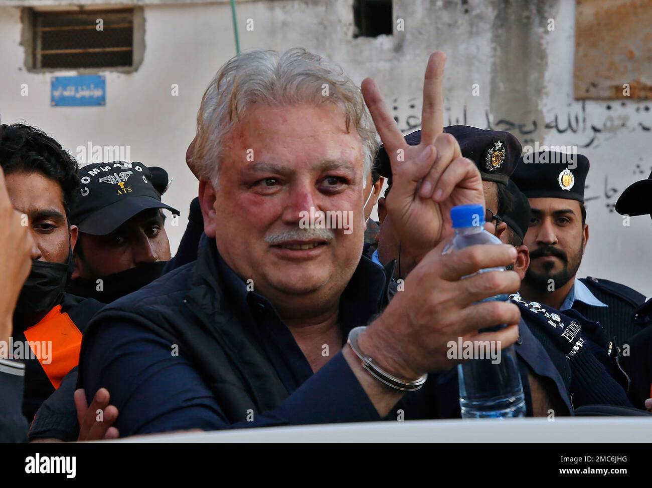 Pakistani journalist Mohsin Baig flashes a victory sign as he leaves ...