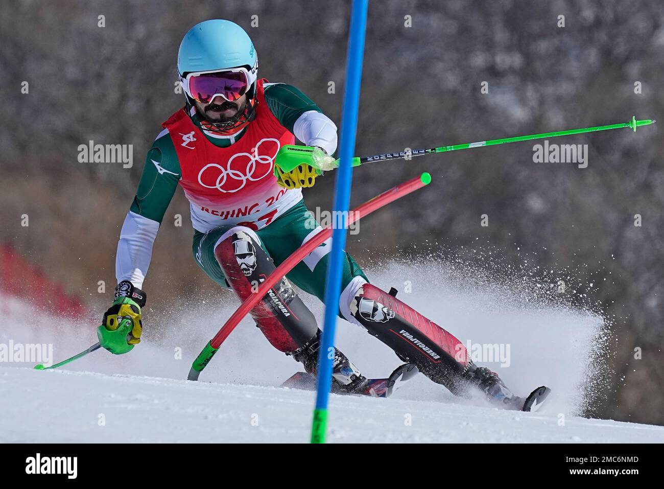 Muhammad Karim, of Pakistan passes a gate during the first run of the ...