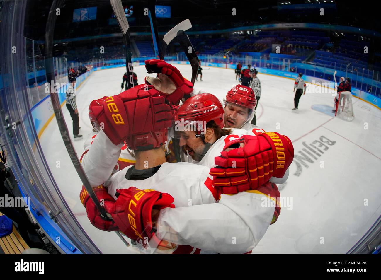China's Jian An (Cory Kane), front left, is congratulated after scoring ...