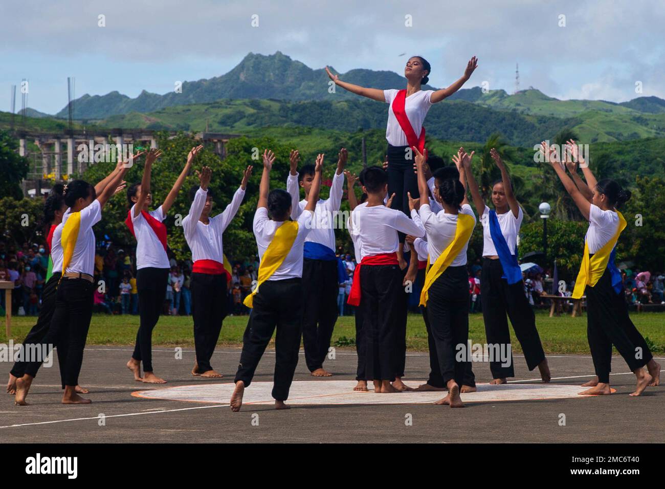 Local students perform a dance routine during a cultural parade ...