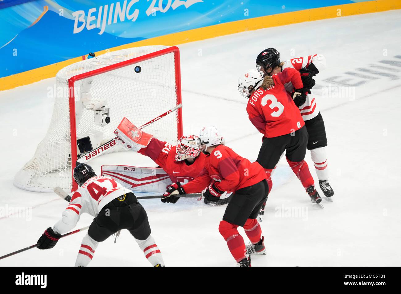 Canada forward Jamie Lee Rattray (47) scores on Switzerland goaltender ...