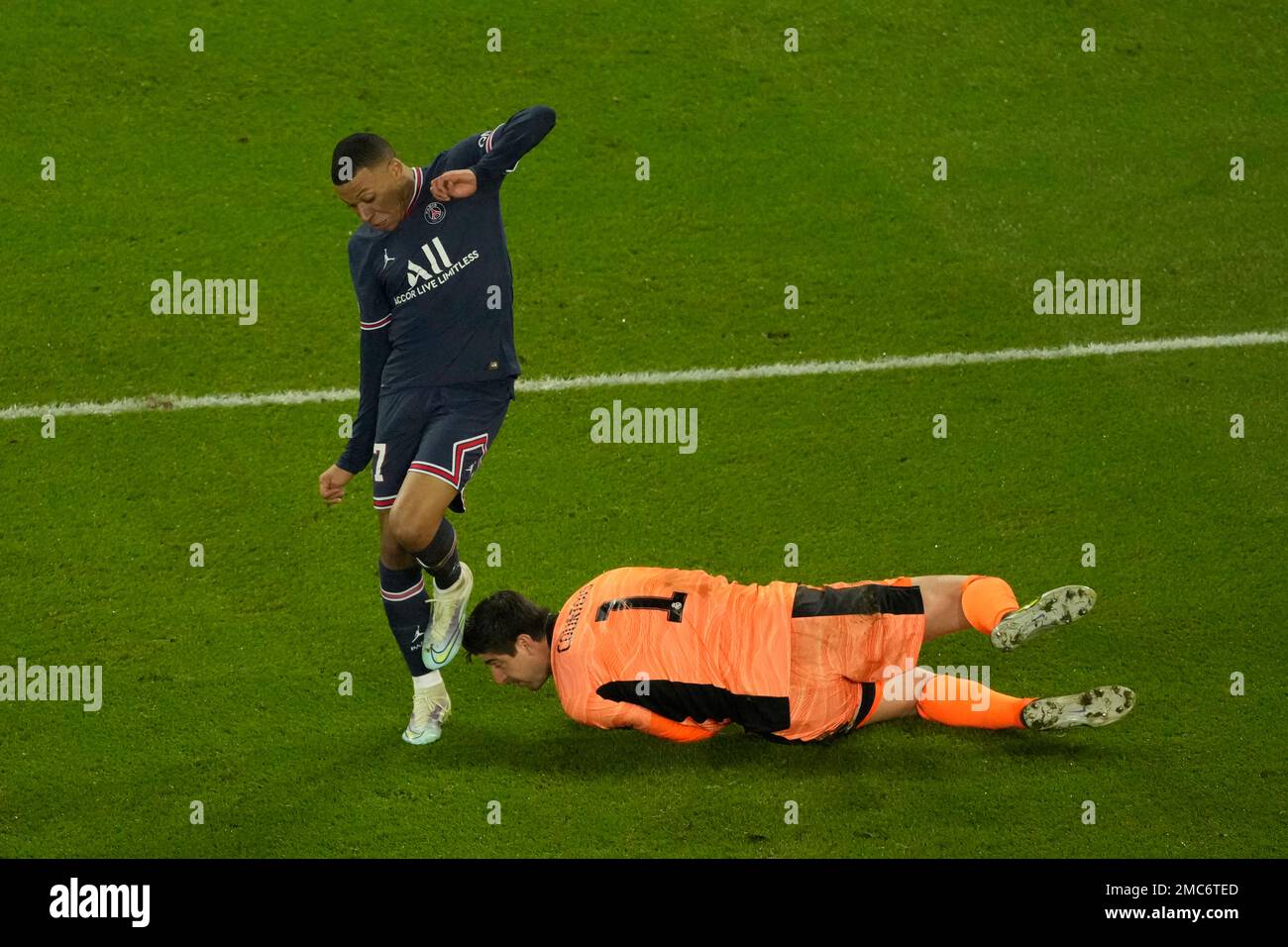 Real Madrid's goalkeeper Thibaut Courtois makes a save in front PSG's ...
