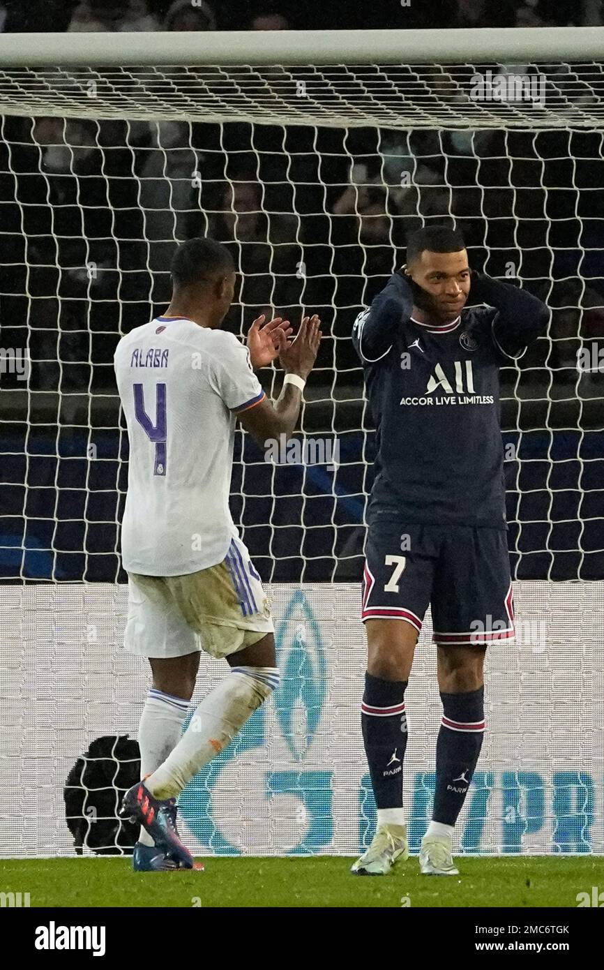 PSG's Kylian Mbappe, right, reacts after missing to score while Real ...