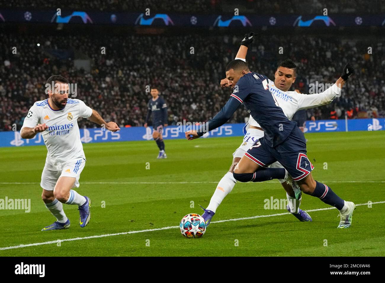 PSG's Kylian Mbappe, right, dribbles Real Madrid's Casemiro, right ...