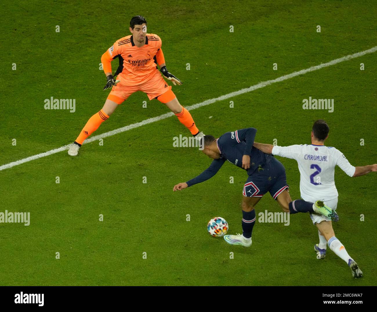 PSG's Kylian Mbappe, center, attempts a shot at goal in front of Real ...
