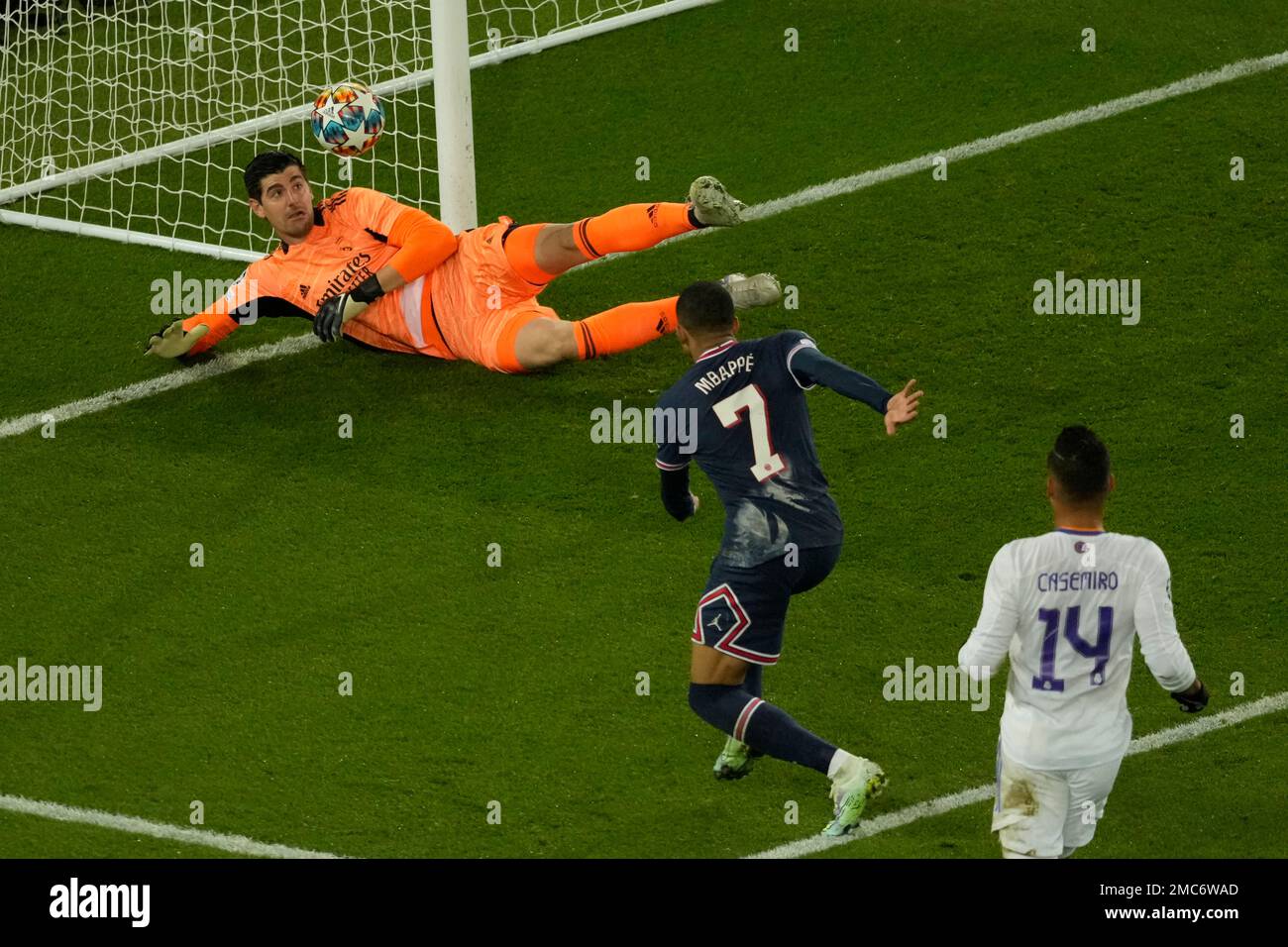 Real Madrid's goalkeeper Thibaut Courtois, top, makes a save in front ...