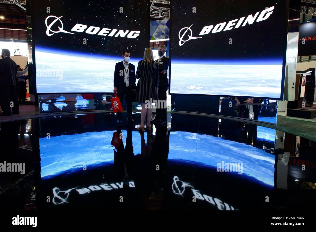 Visitors stand inside the Boeing video booth display during the ...