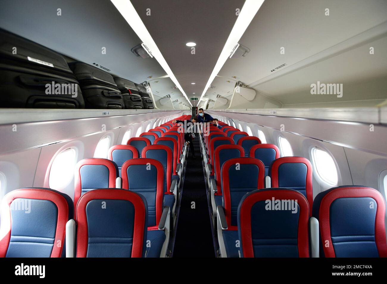 Visitors view the interior of the Embraer E190-E2 commercial jet during ...