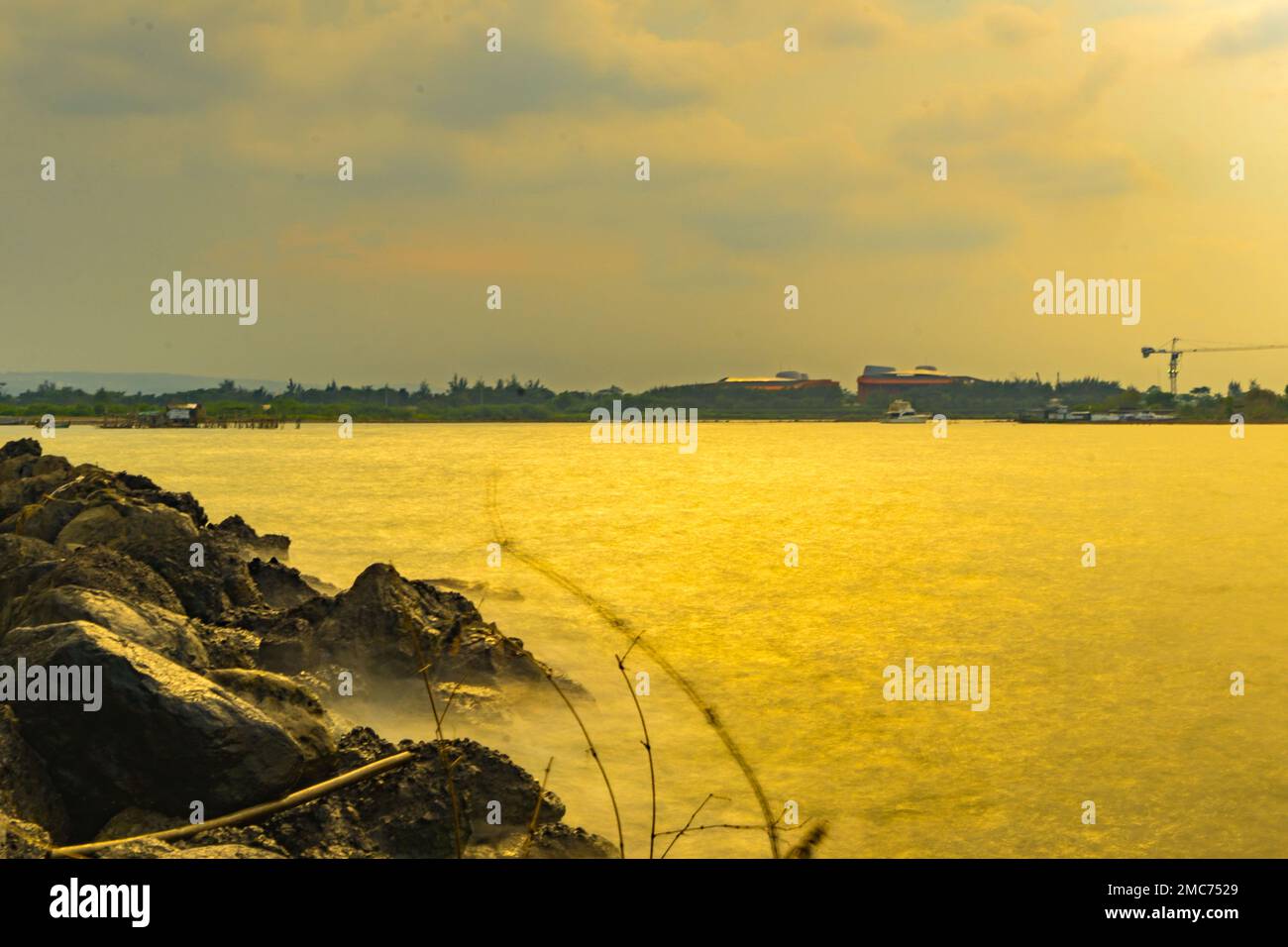 Rocks on the beach during sunset at the Marina Beach Semarang ...