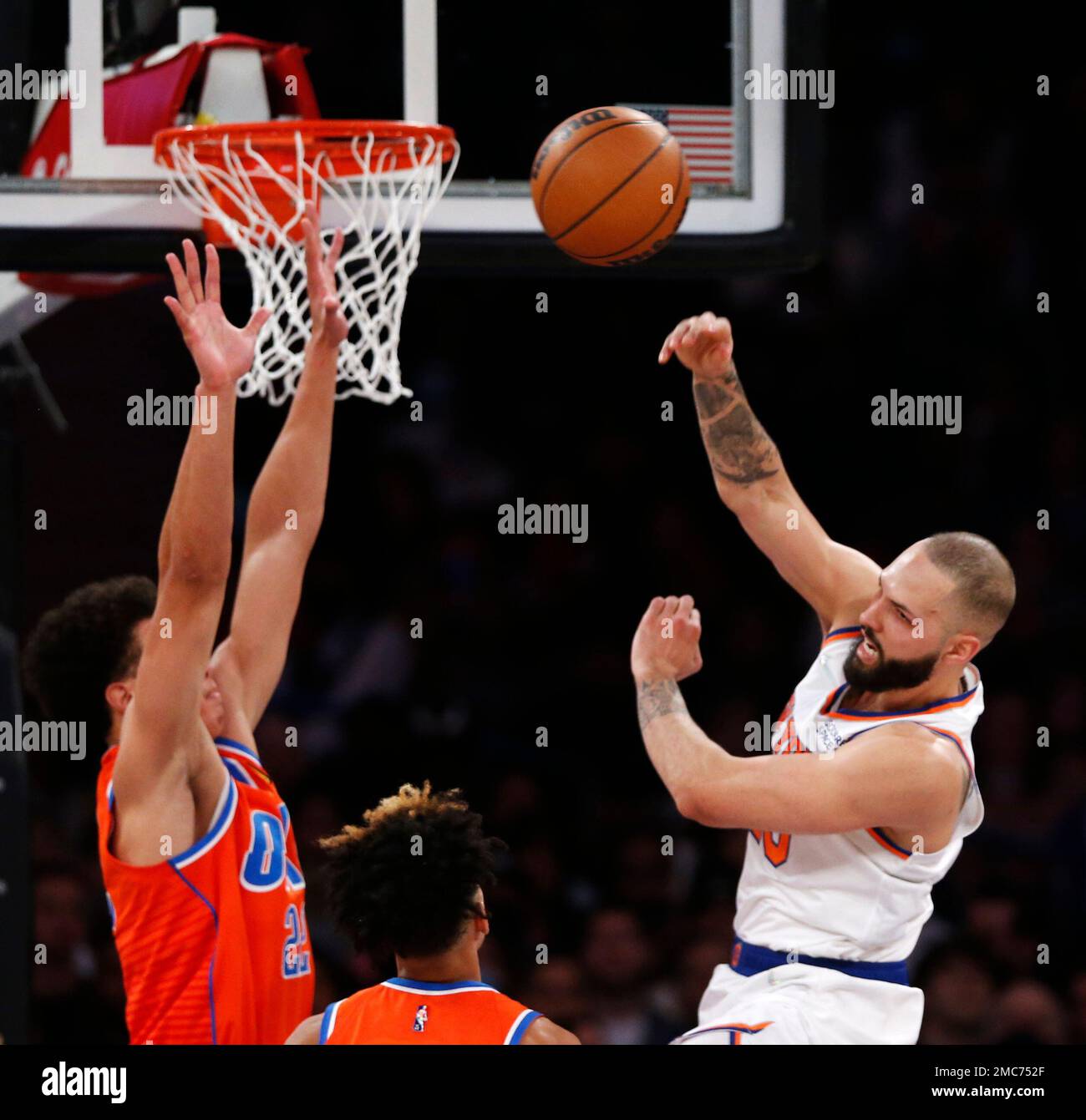 New York Knicks' Evan Fournier, right, passes the ball over Oklahoma ...