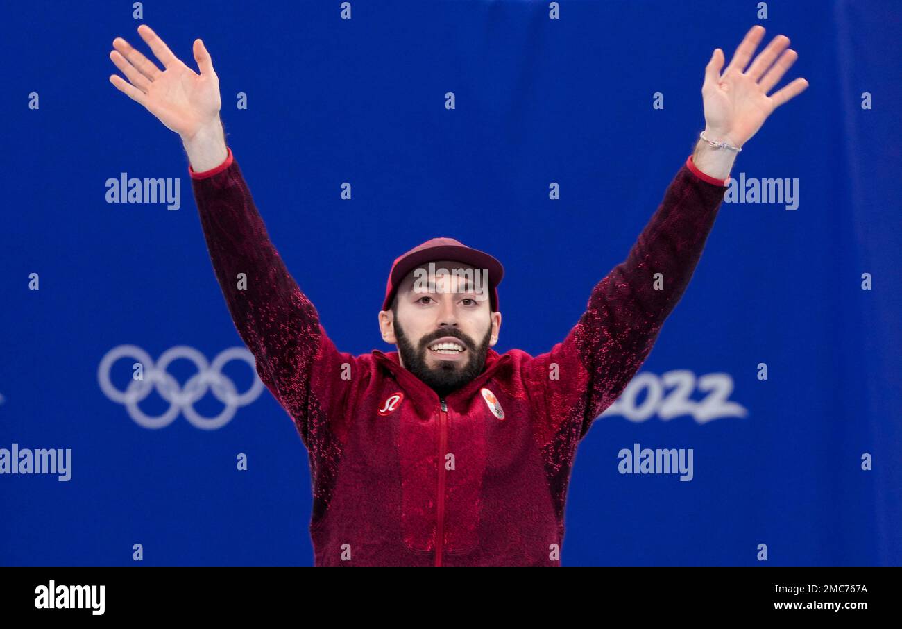 Bronze medalist Steven Dubois of Canada celebrates on the podium during ...