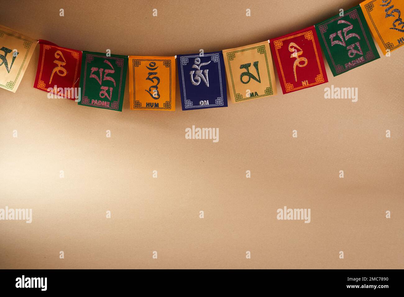 Background with Buddhist Mantra Om Mani Padme Hum on multicolored flags ...