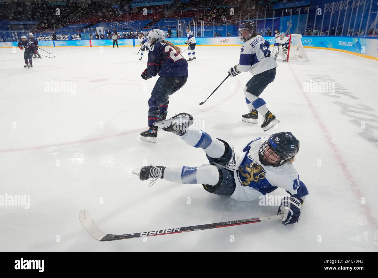 Finland's Noora Tulus (40) falls as she chases the puck during a women ...