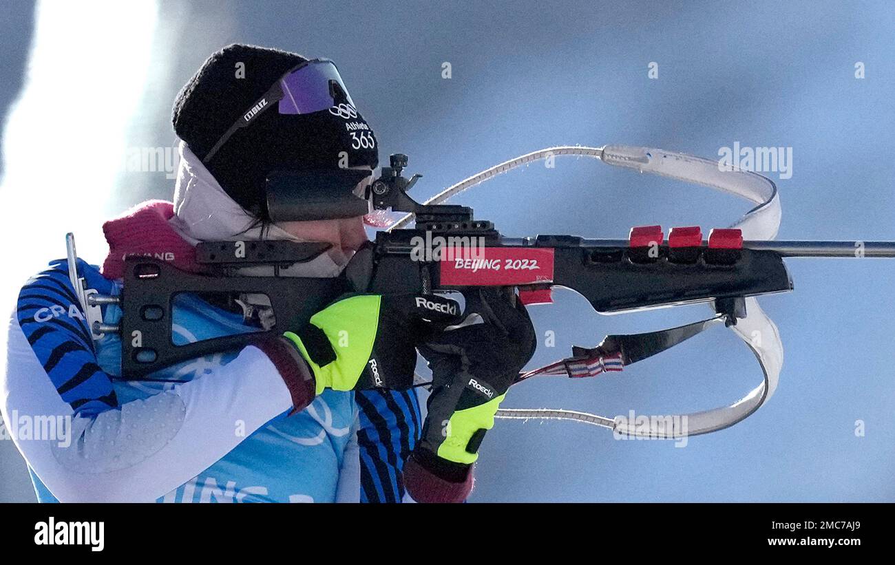 An athlete shoots during a biathlon training session during the 2022 ...