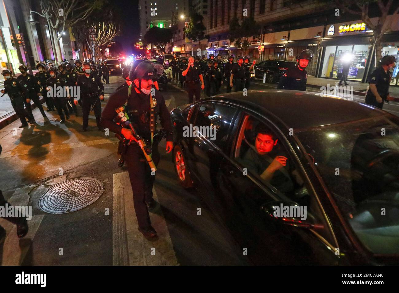 Riot police clear the streets as football fans celebrate after the Los ...