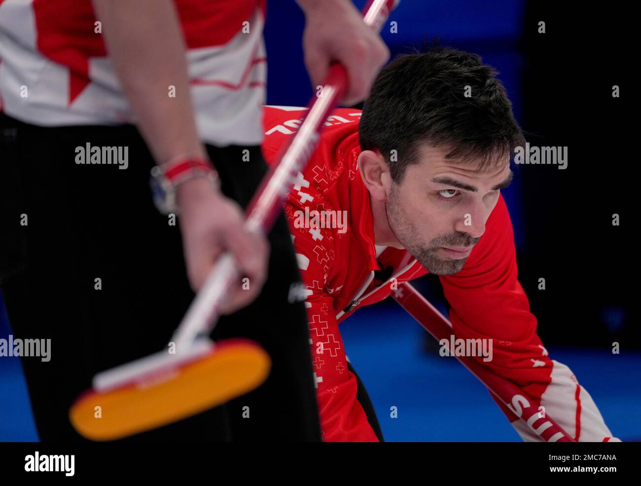 Switzerland's Peter De Cruz, throws a rock, during the men's curling ...