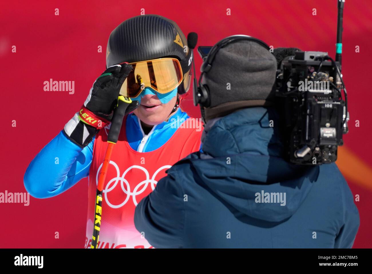 Sofia Goggia, of Italy reacts waves to a TV camera after finishing ...