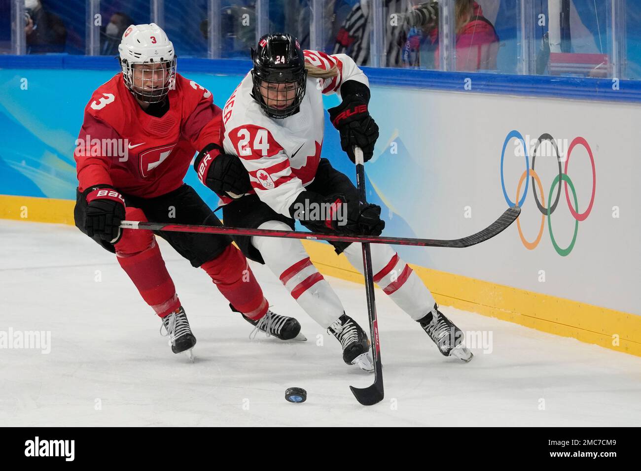 Canada's Natalie Spooner (24) moves the puck ahead of Switzerland's ...