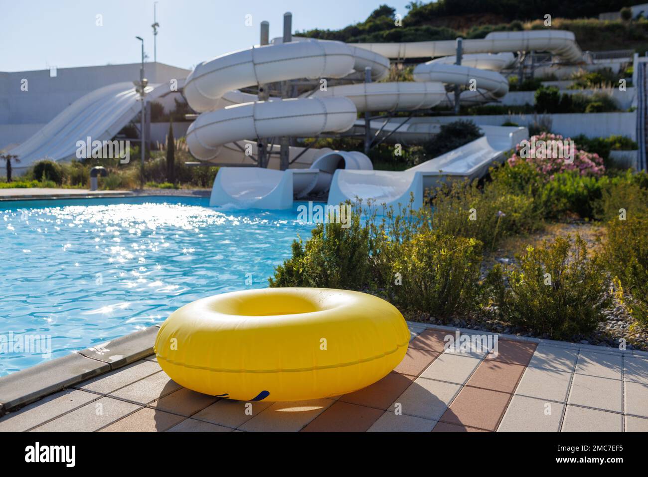 A yellow large inflatable circle lies at the edge of the pool at the ...