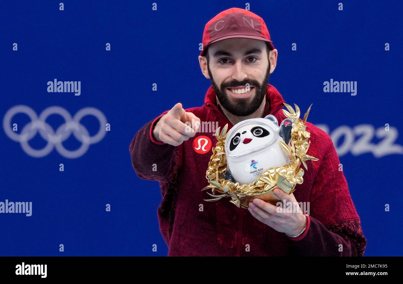 Bronze medalist Steven Dubois of Canada celebrates on the podium during ...