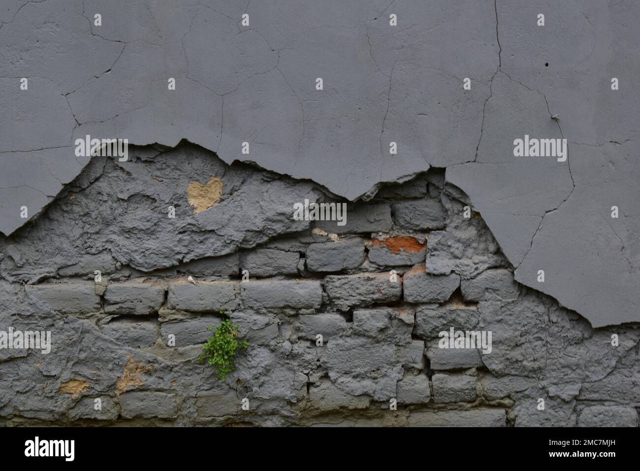 Old brick, damaged, gray wall concept background Stock Photo - Alamy