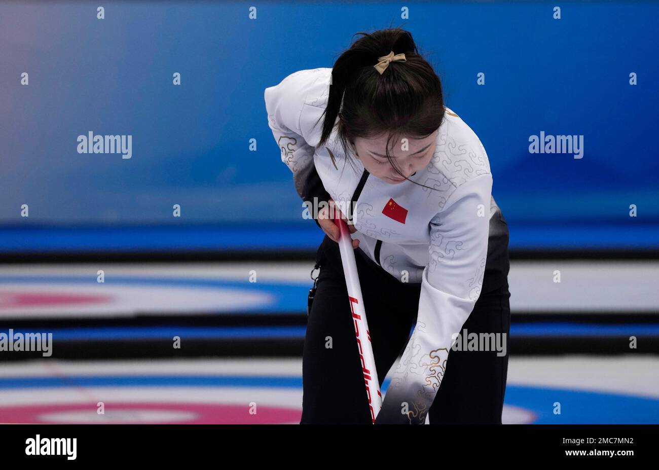 China's Han Yu sweeps the ice during the women's curling match against ...