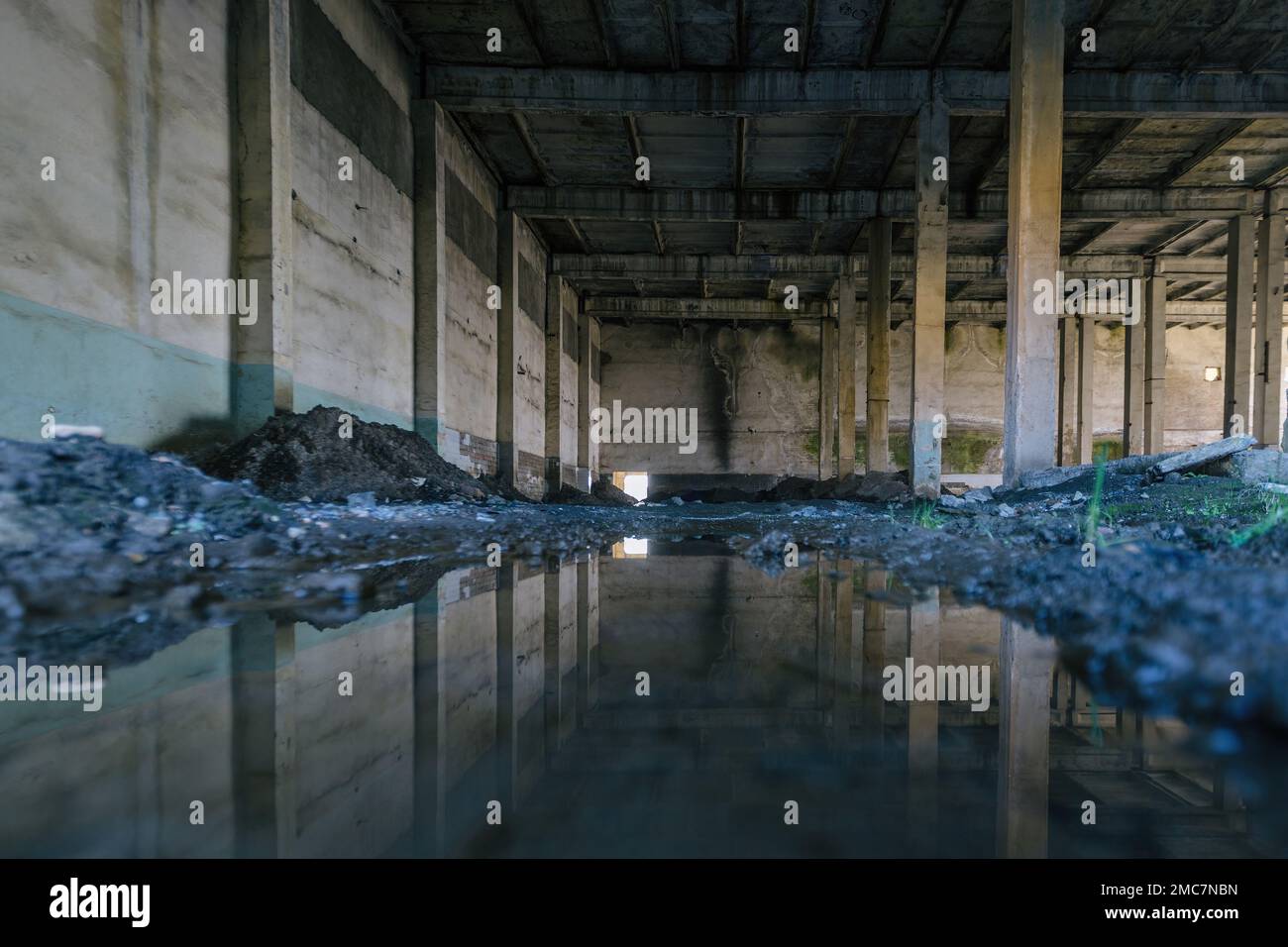 Inside of flooded dirty abandoned ruined industrial building with water ...